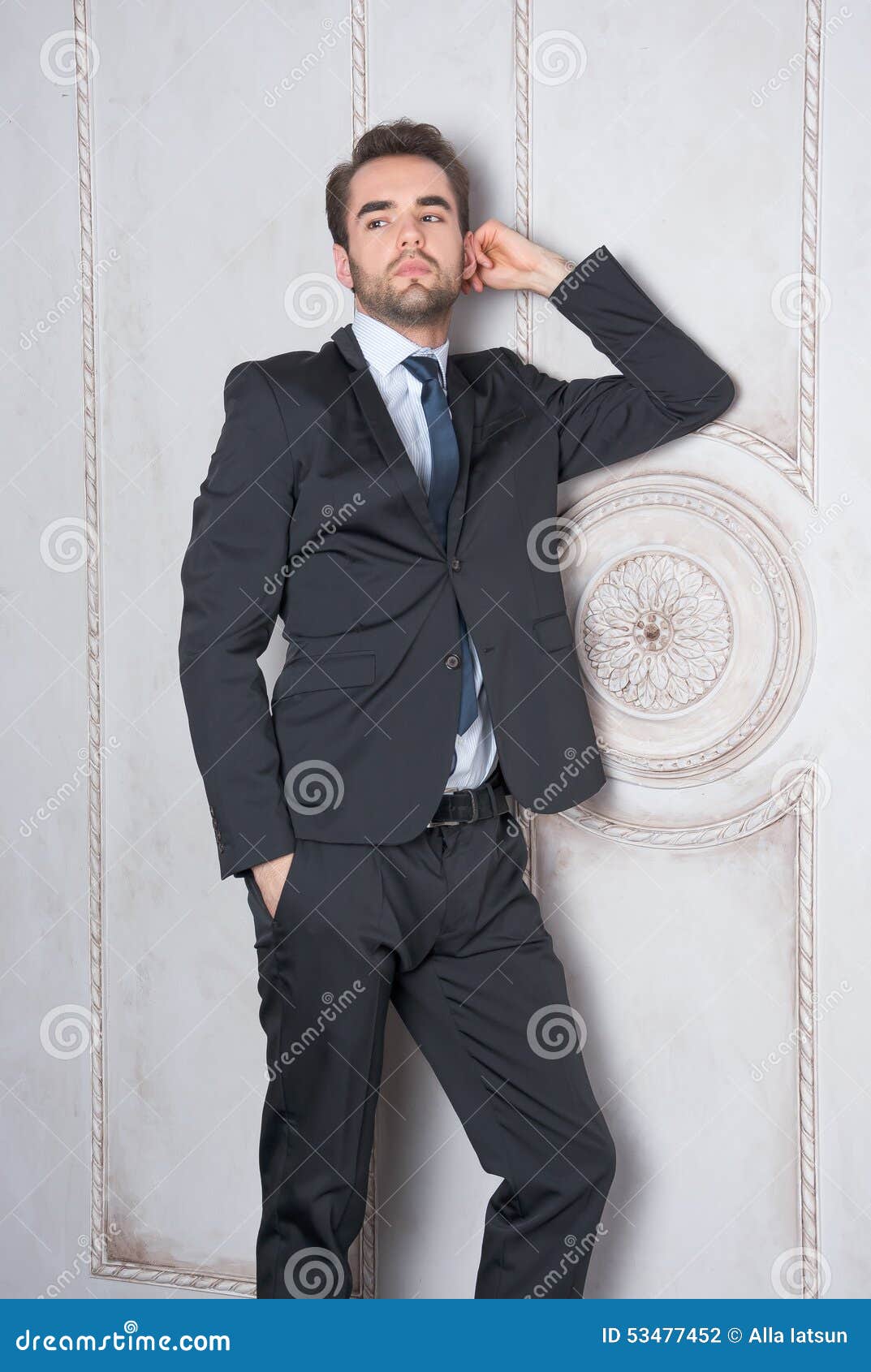 Young Man in a Suit in Front of a Wall Stock Photo - Image of males ...