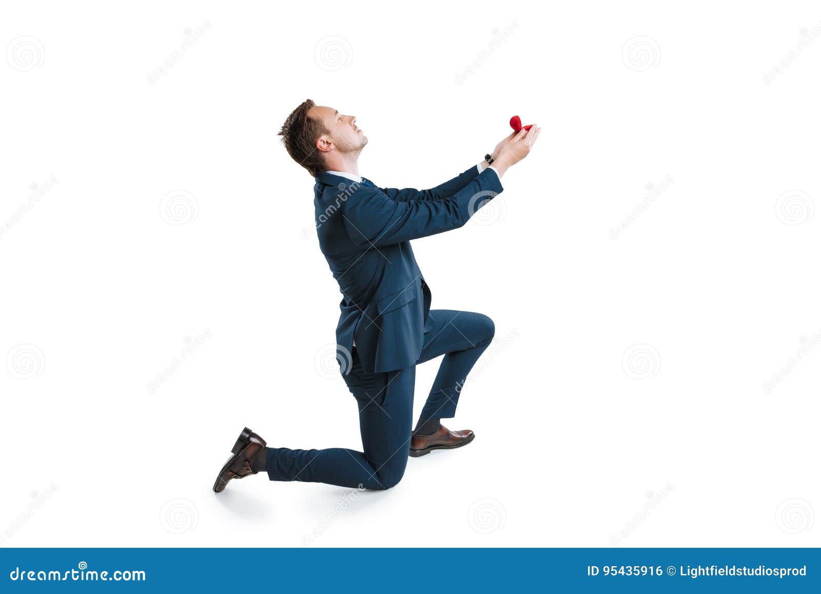 Young Man in Suit Standing on One Knee and Making Marriage Proposal ...