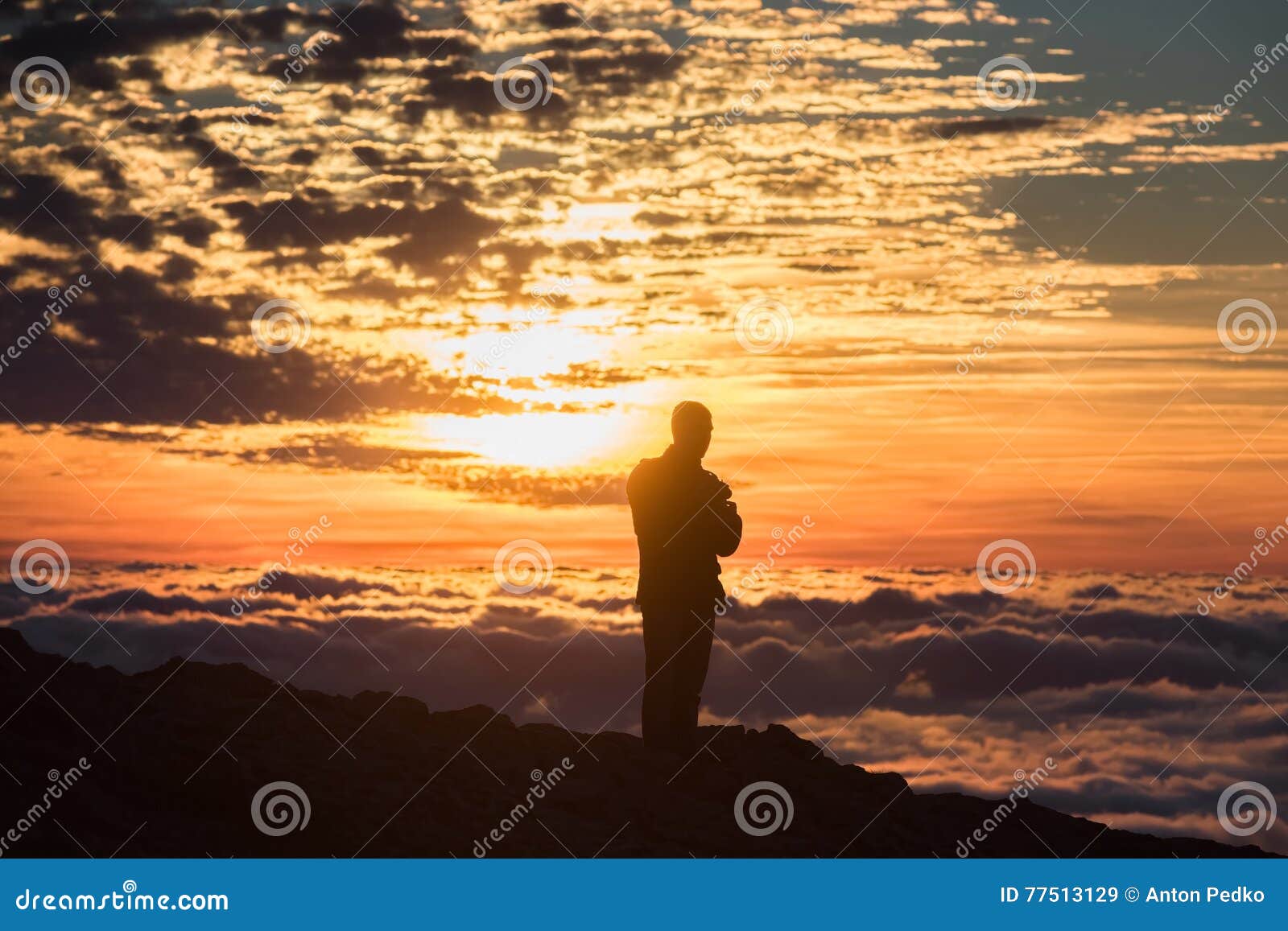 Young Man on Sunset Above the Clouds in the Mountains Stock Image ...