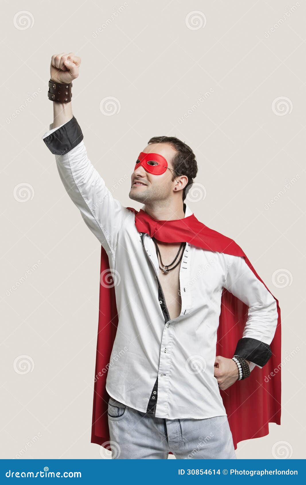 Young Man in Superhero Costume Standing Against Gray Background Stock ...