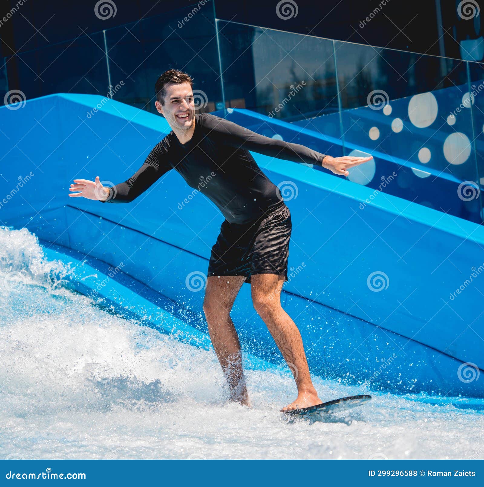 Young Man Surfing on a Wave Simulator at a Water Amusement Park Stock ...