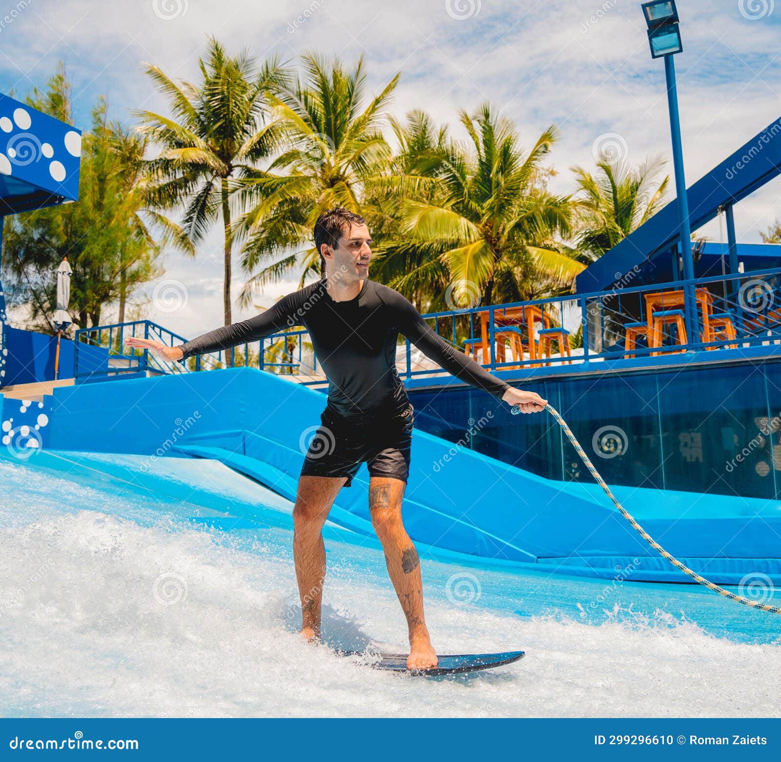Young Man Surfing on a Wave Simulator at a Water Amusement Park Stock ...