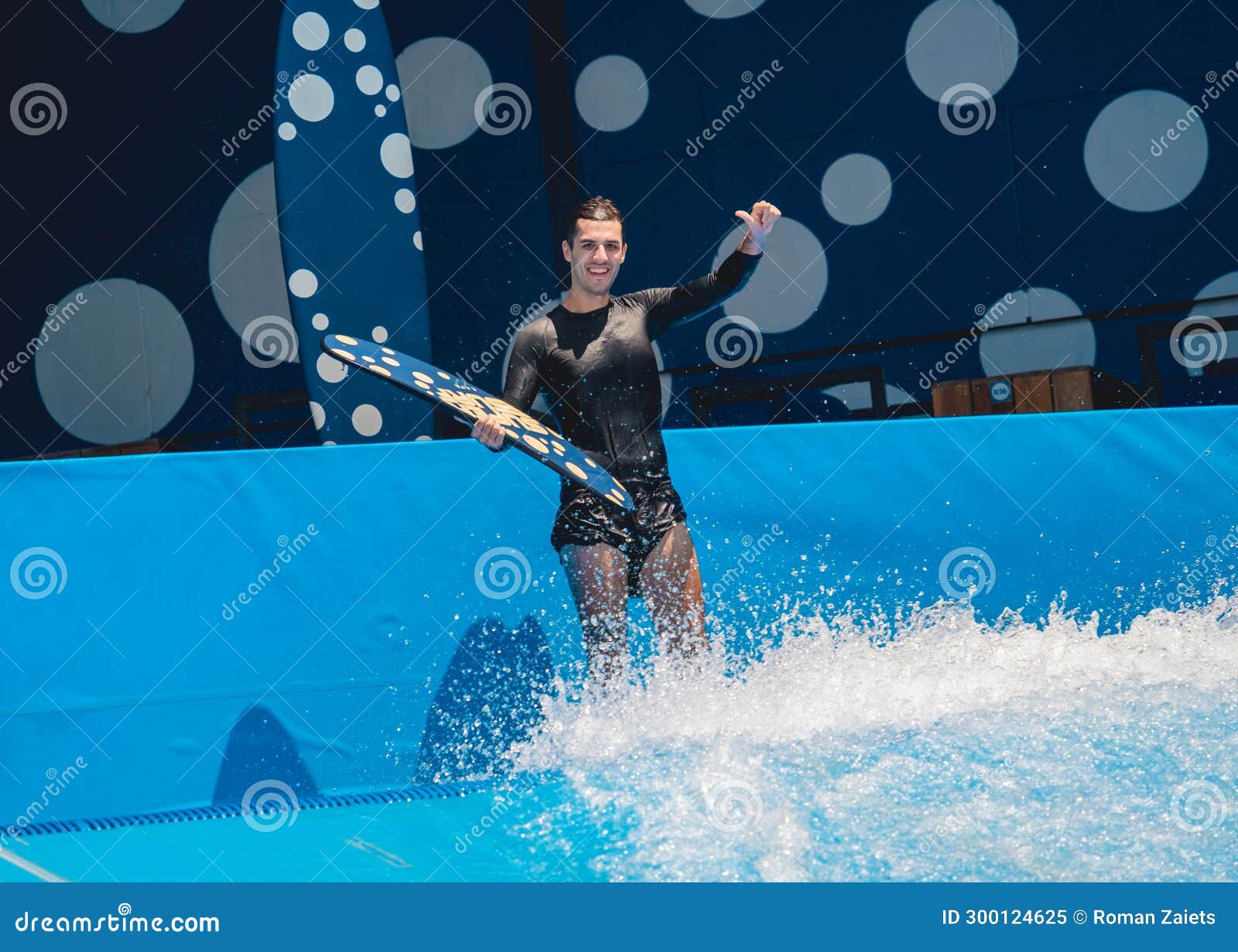 Young Man Surfing on a Wave Simulator at a Water Amusement Park Stock ...