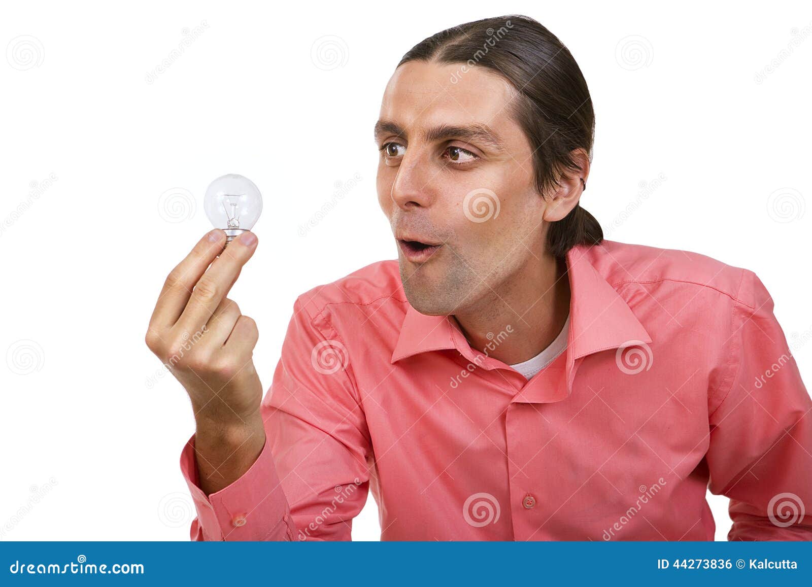 Young Man an with Surprised Looks at a Light Bulb Stock Photo - Image ...