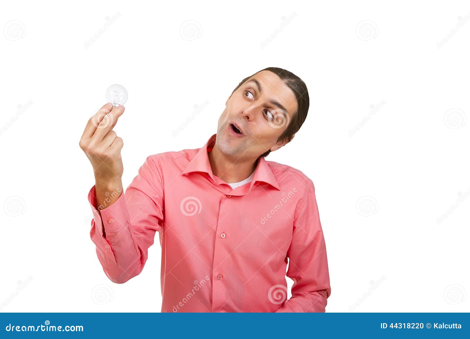 Young Man an with Surprised Looks at a Light Bulb Stock Photo - Image ...