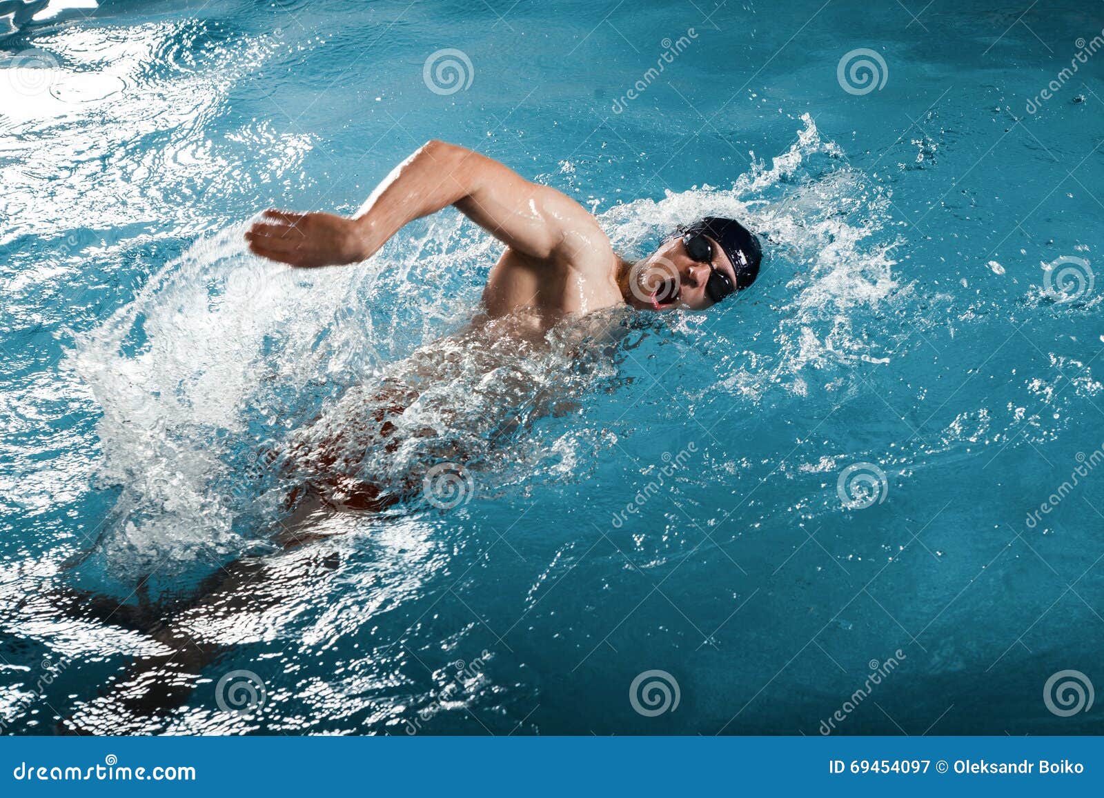 Young man swimming a pool stock image. Image of hobby - 69454097