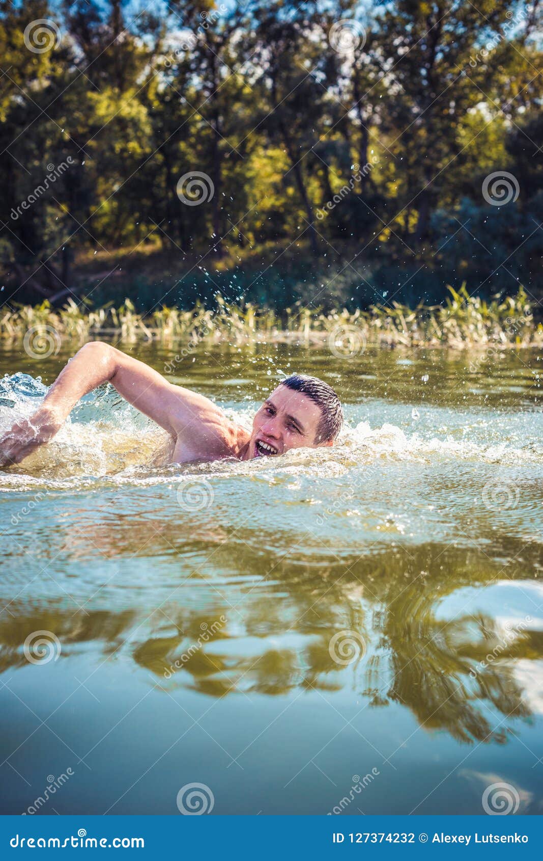 The Young Man Swimming in the River Stock Photo - Image of nature ...