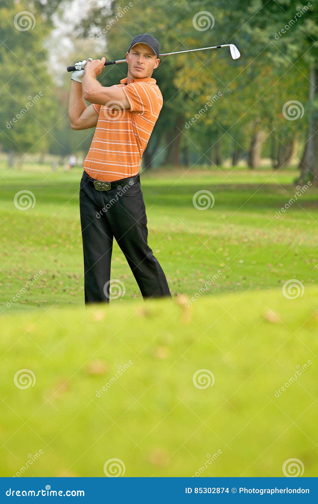 Young Man Swinging Golf Club Stock Photo - Image of activity, three ...