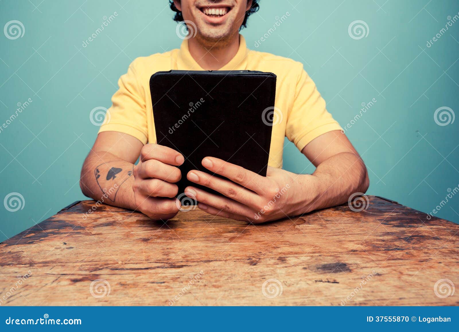 Young Man at Table Reading on Tablet Stock Photo - Image of asian ...