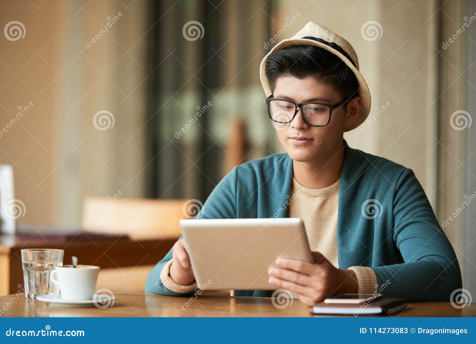 Young man with tablet stock image. Image of asian, male - 114273083