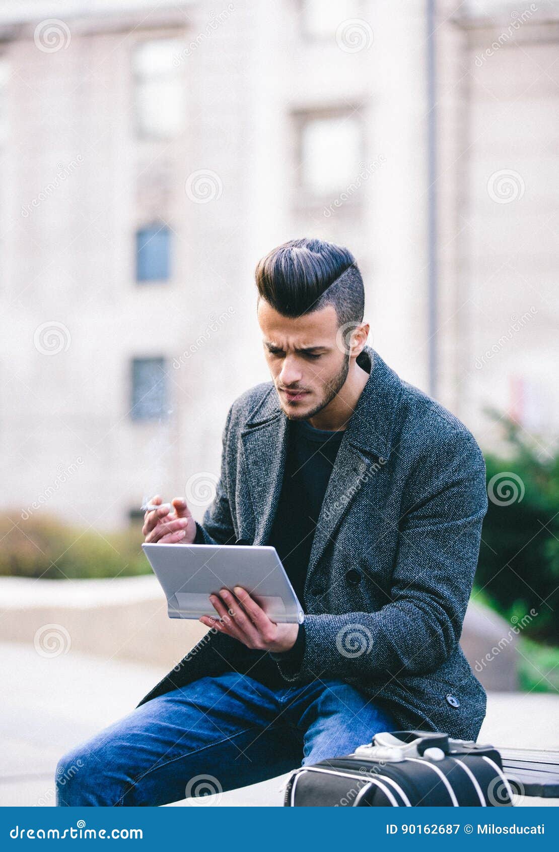 Young man with tablet stock image. Image of booking, grey - 90162687