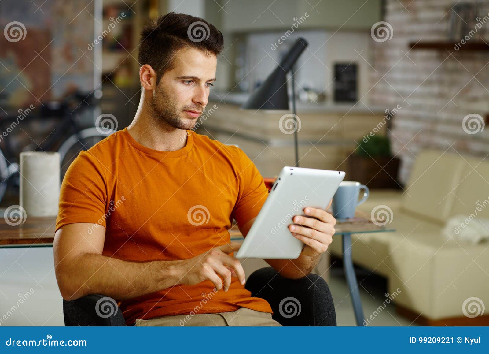 Young man with tablet stock image. Image of browsing - 99209221 Young man with tablet stock image. Image of browsing - 99209221