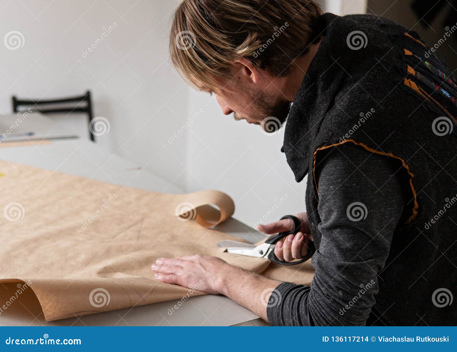 Young Man Tailor with Scissors Making Clothing Pattern Stock Photo ...