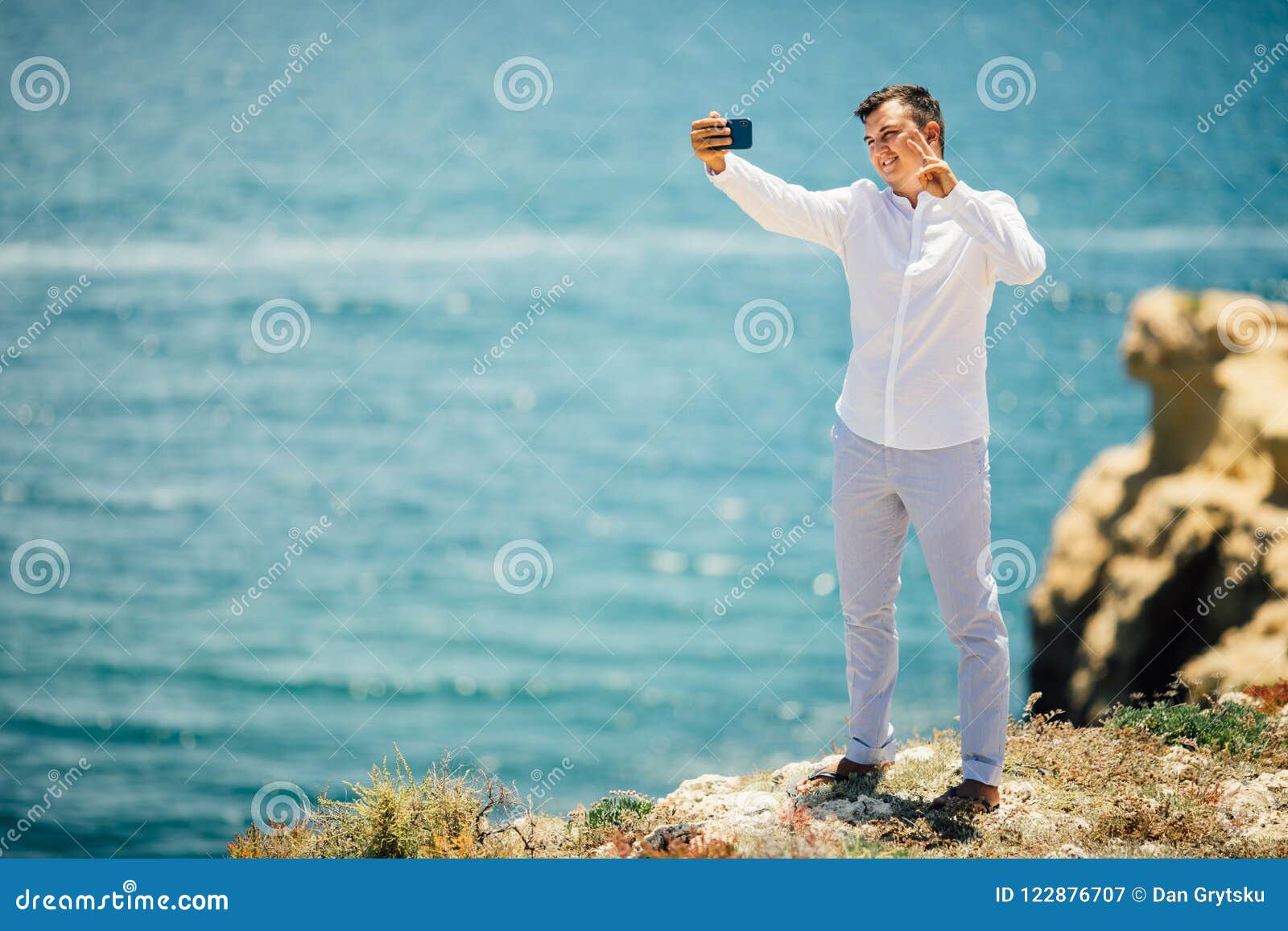 Young Handsome Man Take Selfie With Victory Sign On The Ocean Coast
