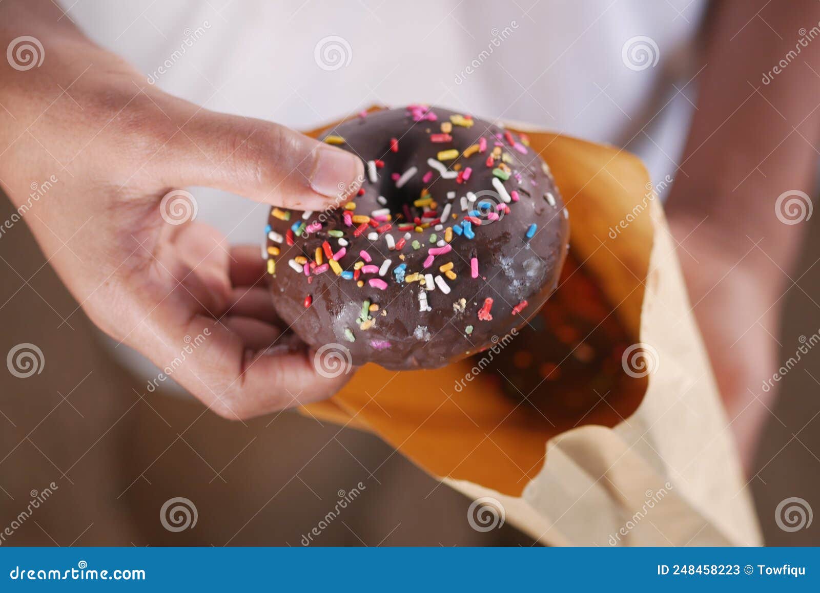 Young Man Taking Donuts Out from a Packet Stock Image - Image of ...