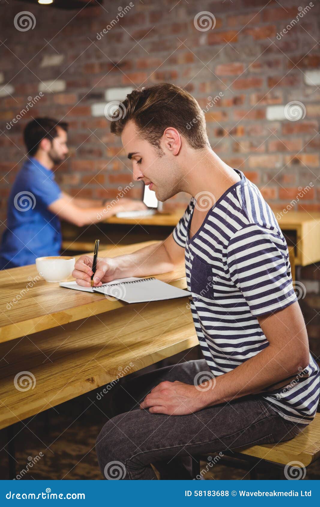 Young Man Taking Notes in His Notebook Stock Photo - Image of coffee ...
