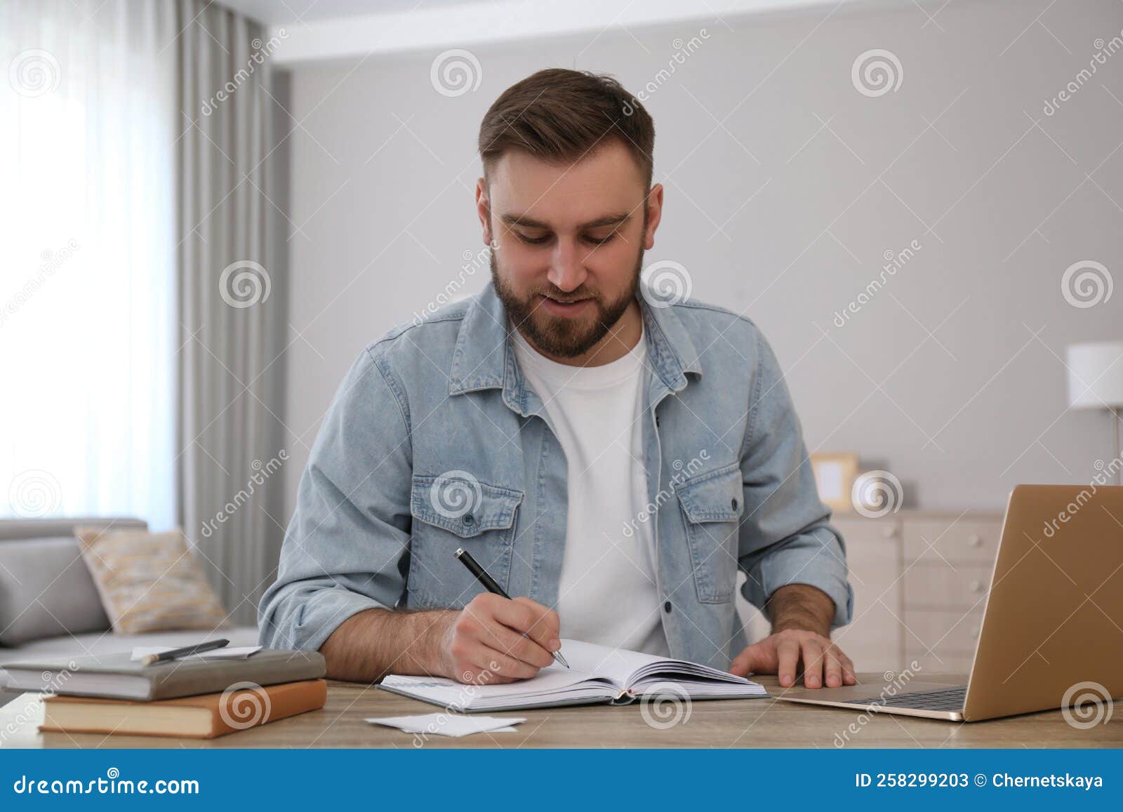 Young Man Taking Notes during Online Webinar at Table Indoors Stock ...