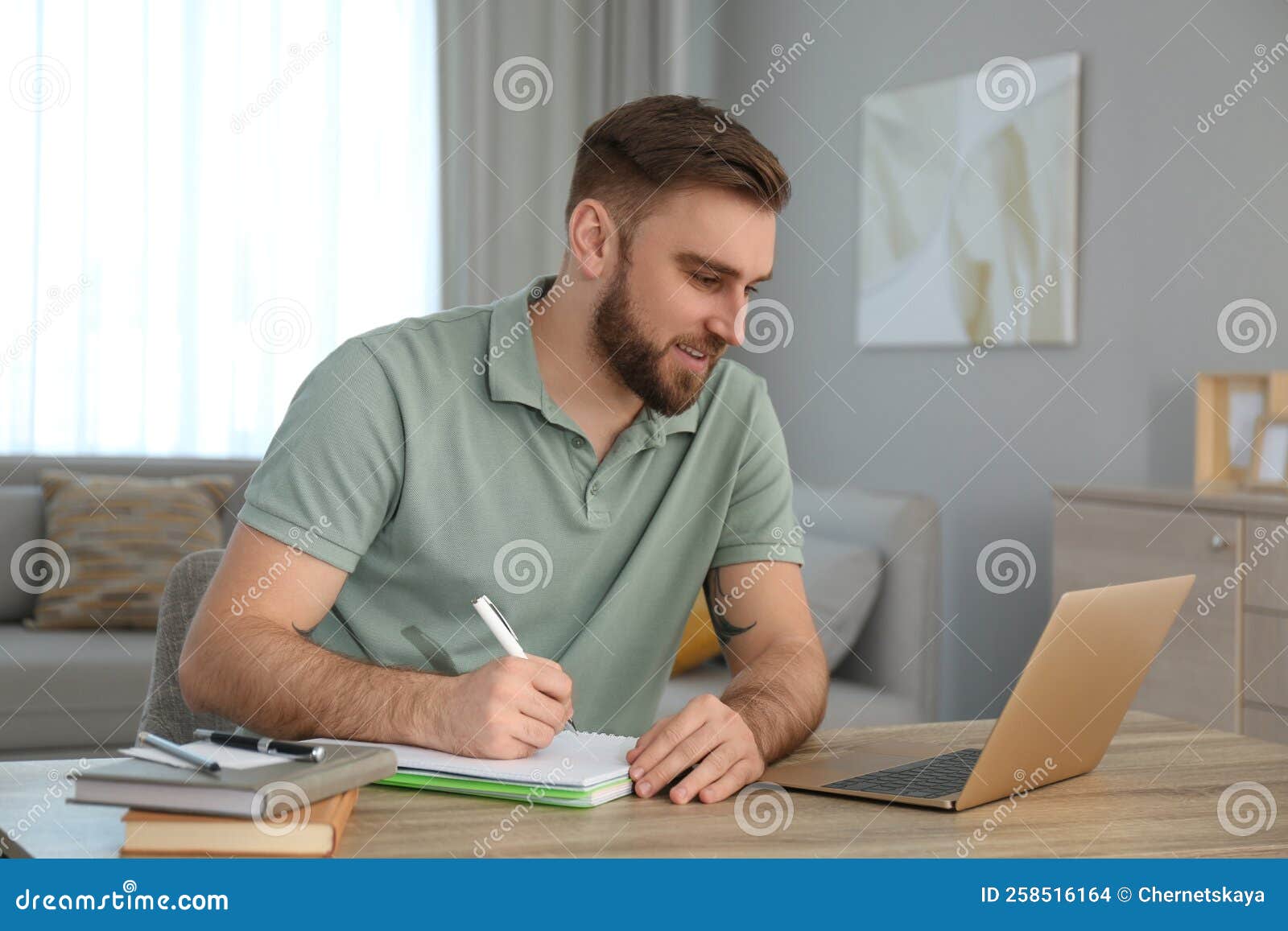Young Man Taking Notes during Online Webinar at Table Indoors Stock ...