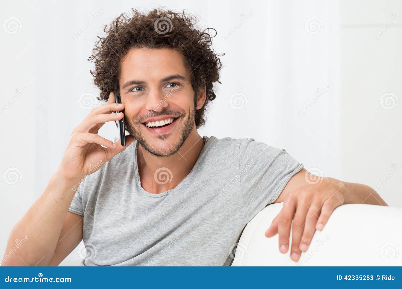Young Man Talking on Cellphone Stock Image - Image of leaning, mobile ...
