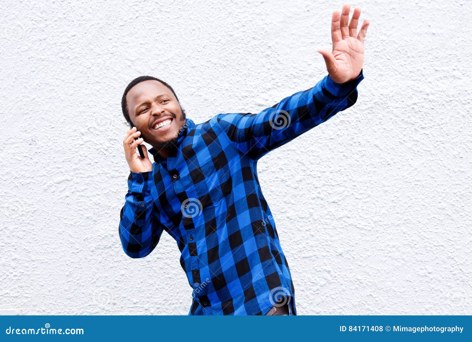 Young Man Talking on Cellphone and Waving Hand Stock Photo - Image of ...
