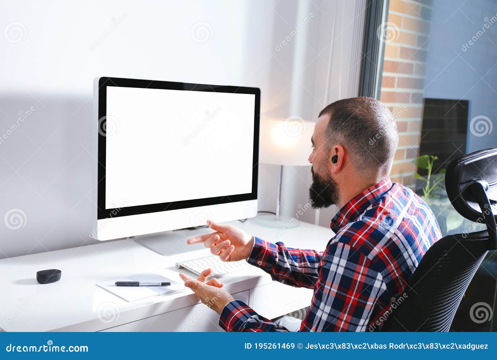 Young Man Talking in Front of Computer with Blank Screen in Video Call ...