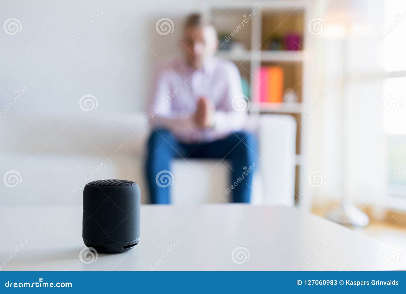Man Talking To Virtual Assistant Smart Speaker in Living Room Stock ...