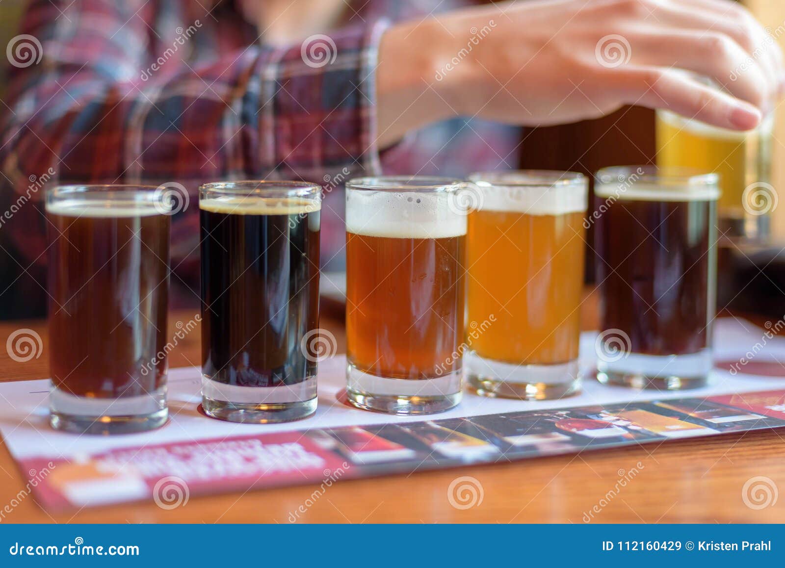 Young Man Tasting Beer Samples from a Beer Flight Stock Image - Image ...