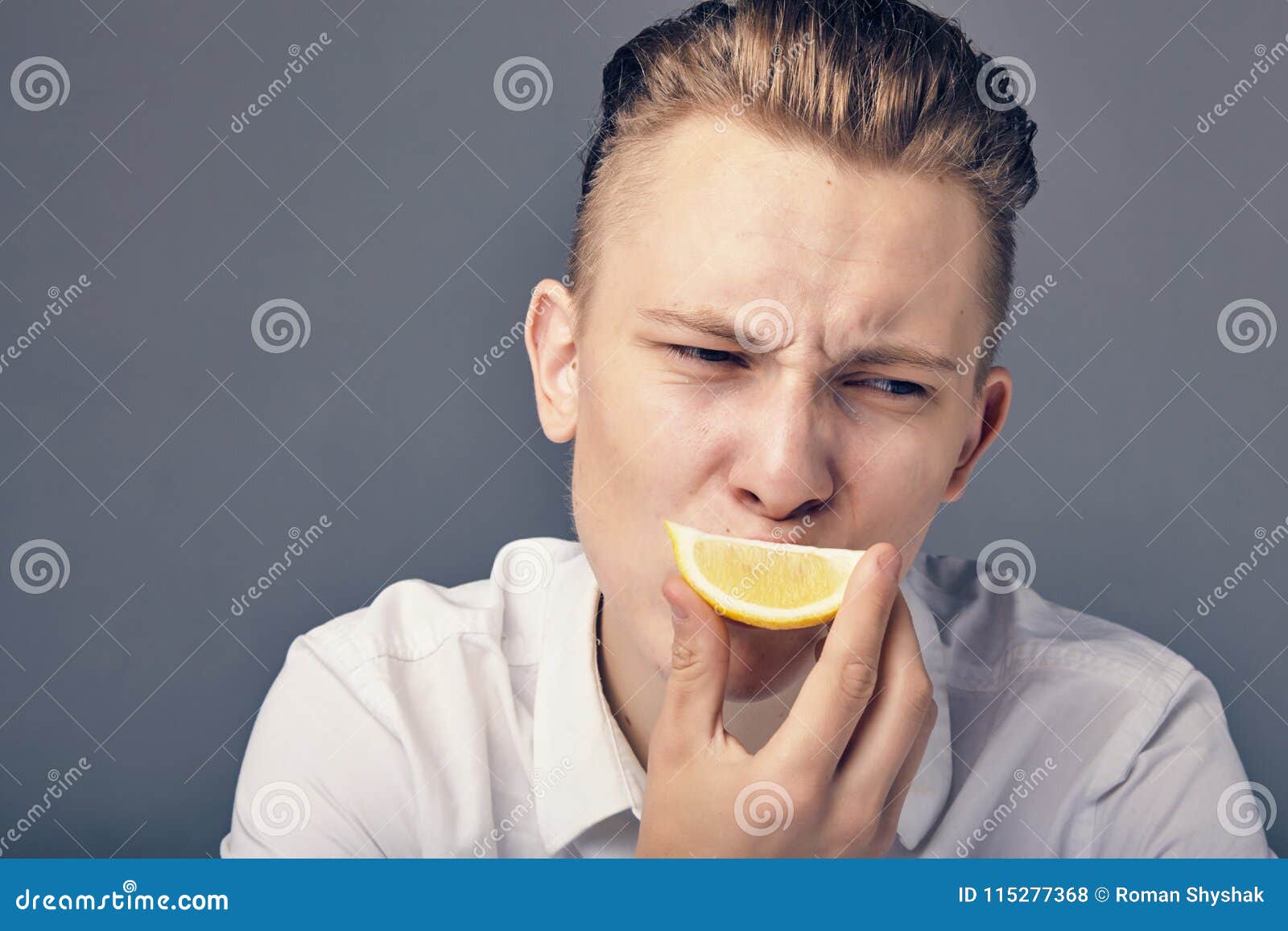 Young man tasting lemon. stock photo. Image of adult - 115277368