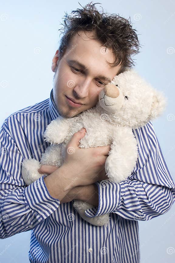 Young man with a teddy stock image. Image of cheerful - 10625301