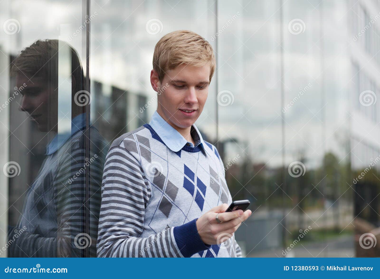 Young man texting stock image. Image of texting, standing - 12380593