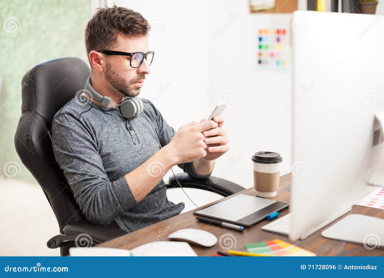 Young Man Texting at the Office Stock Photo - Image of hispanic ...