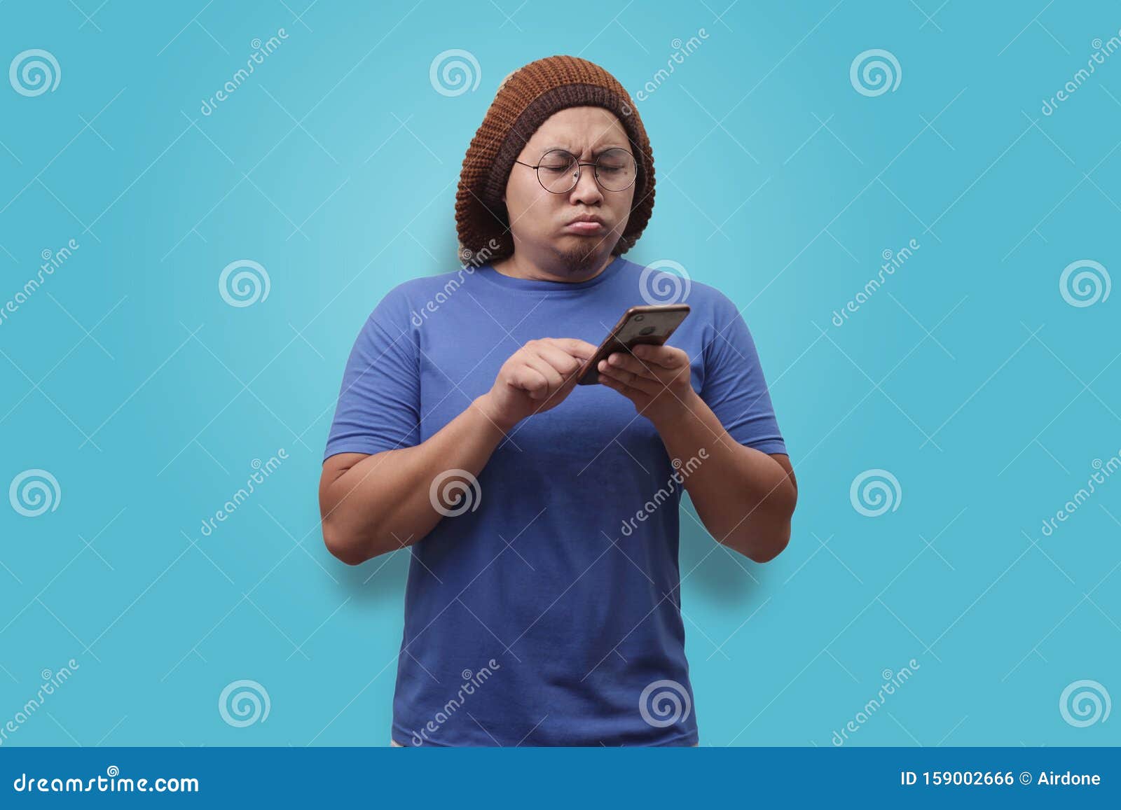 Young Man Texting Reading Chatting on His Phone, Confused Expression ... Young Man Texting Reading Chatting on His Phone, Confused Expression ...