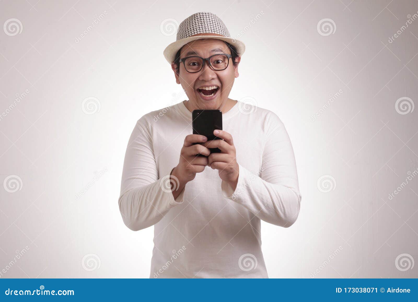 Young Man Texting Reading Chatting on His Phone, Smiling Happy Stock ... Young Man Texting Reading Chatting on His Phone, Smiling Happy Stock ...