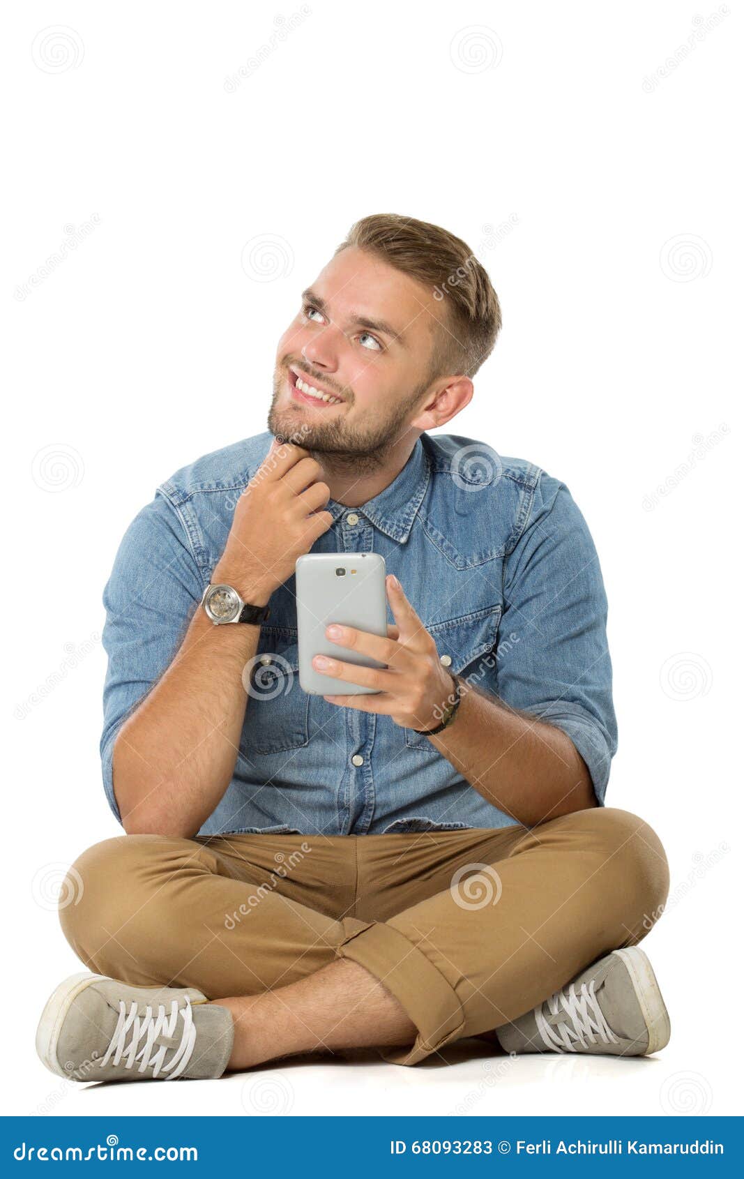Young Man Thinking while Holding a Cellphone and Sitting on the Stock ...