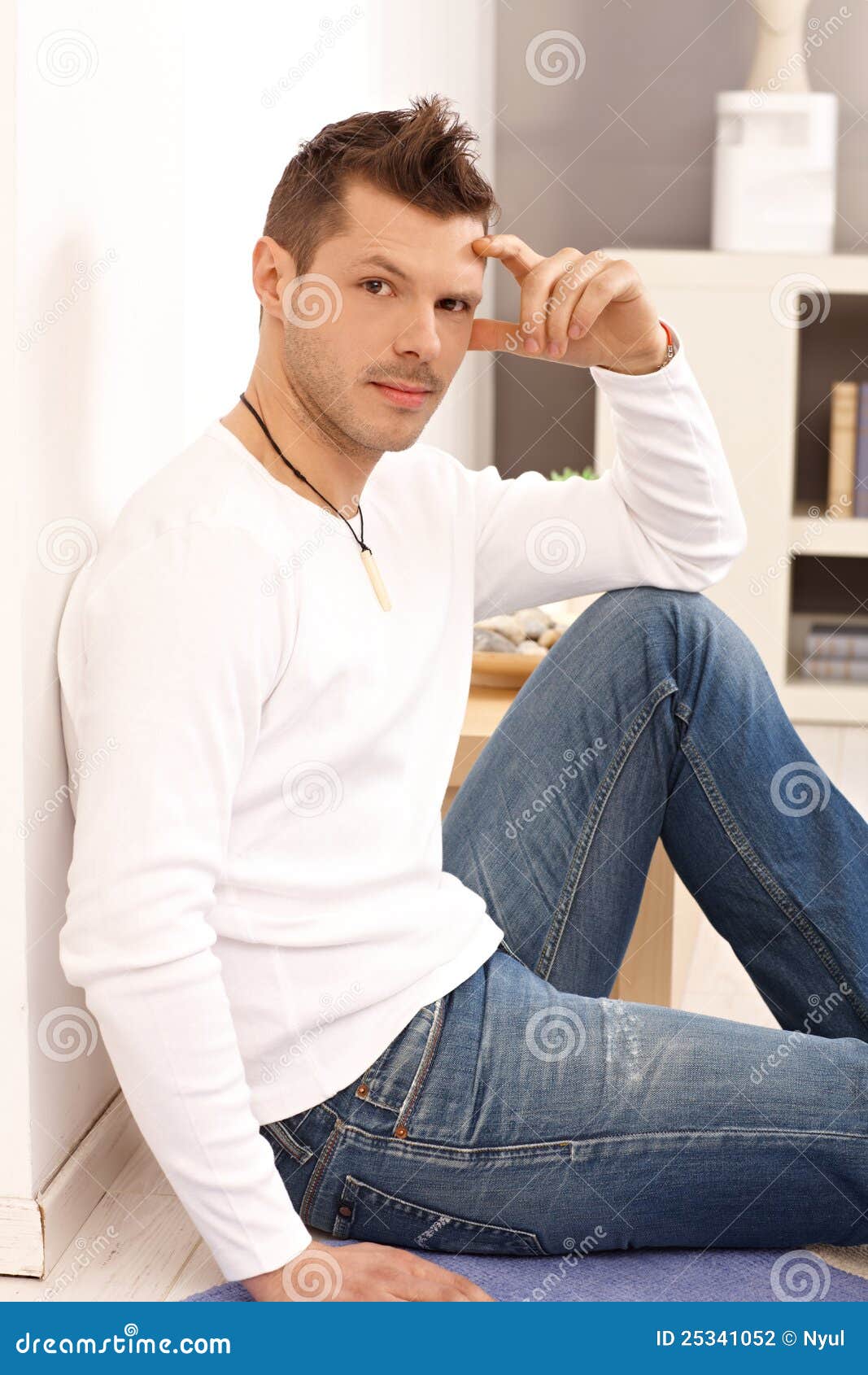 Young man thinking at home stock photo. Image of people - 25341052