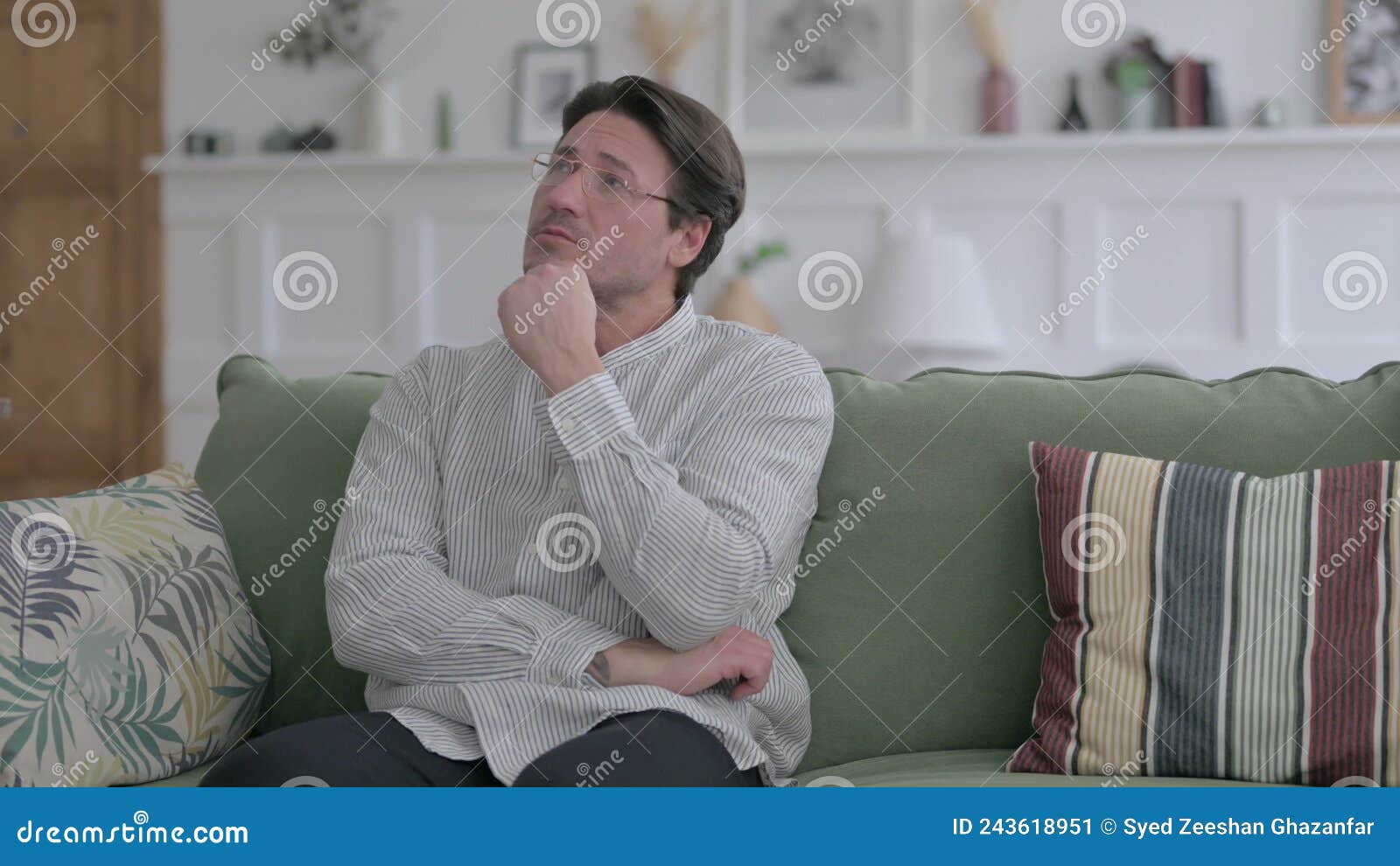 Young Man Thinking while Sitting on Sofa Stock Video - Video of home ...