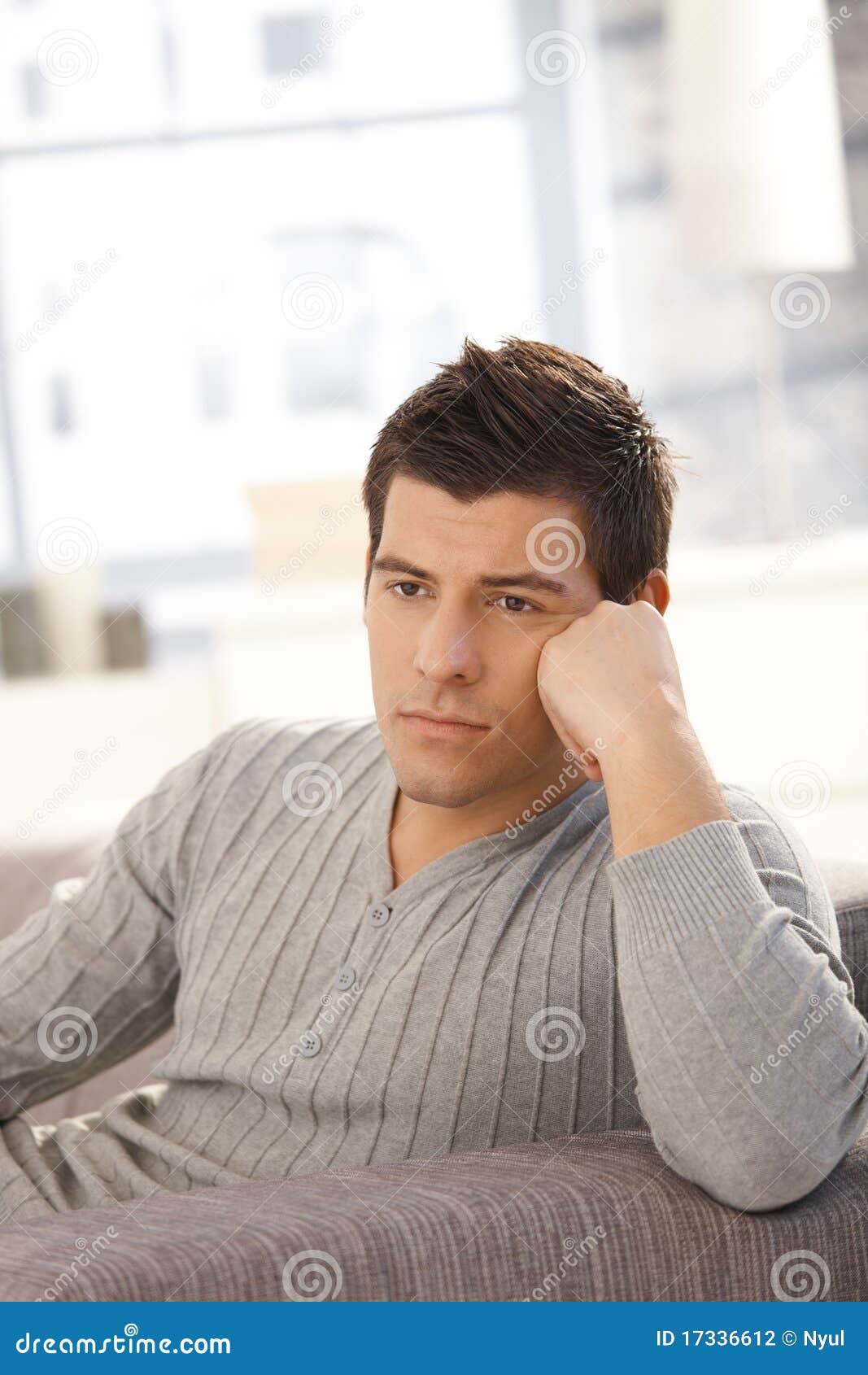 Young man thinking on sofa stock photo. Image of lifestyle - 17336612
