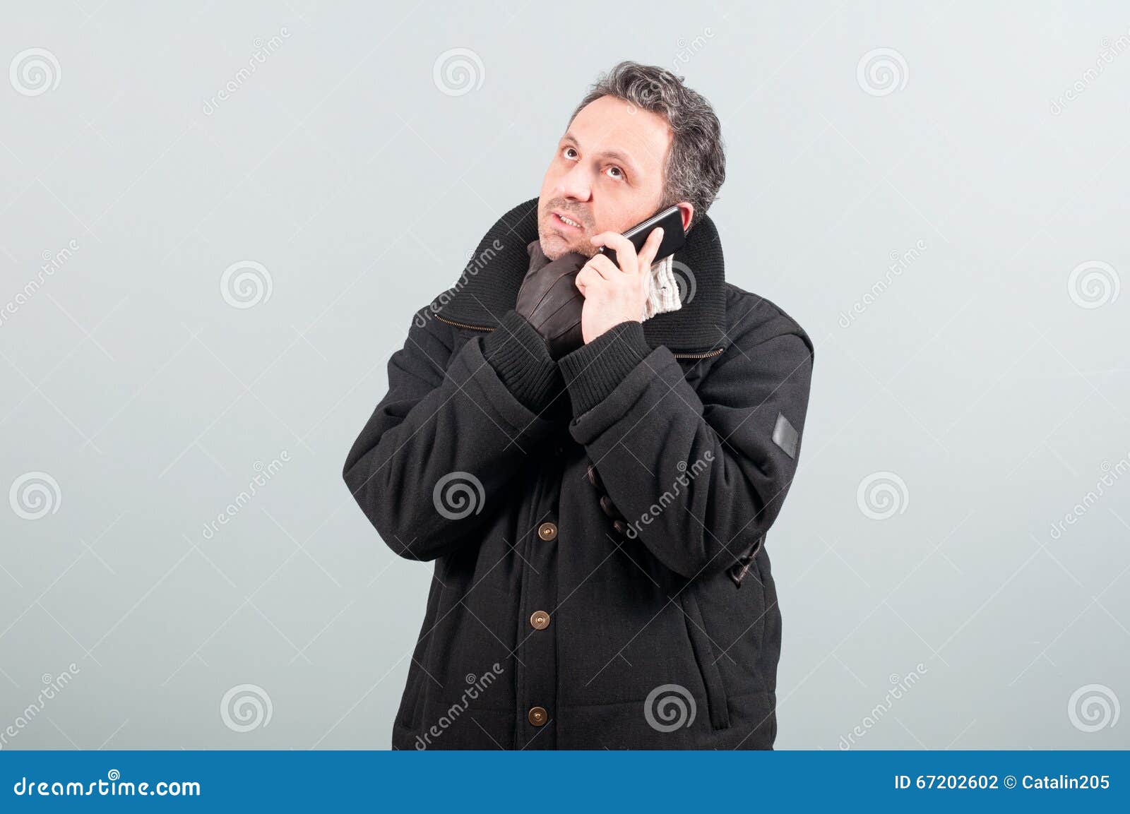 Young Man Thinking while Talking on Cellphone Stock Photo - Image of ...