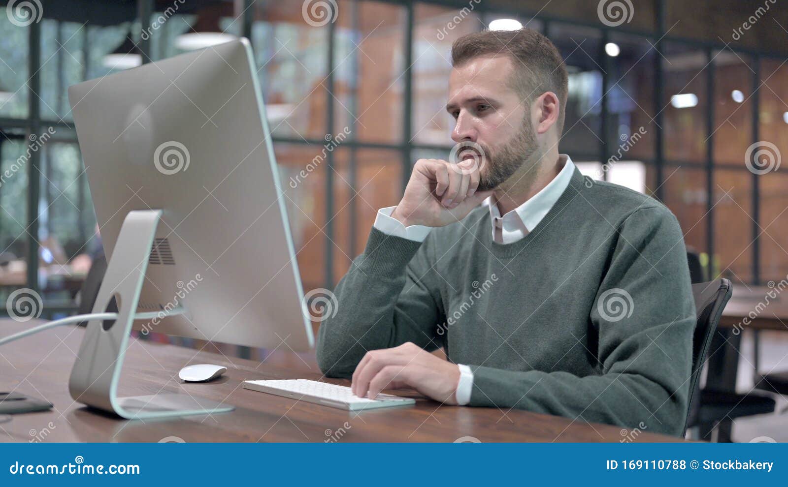 Young Man Thinking while Working on Computer Stock Photo - Image of ...