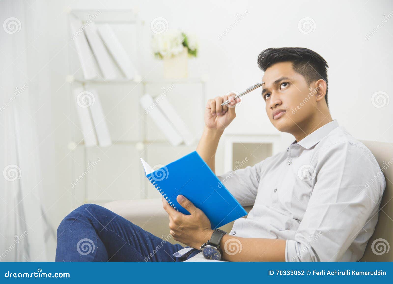 Young Man Thinking while Writing on a Book Stock Photo - Image of ...