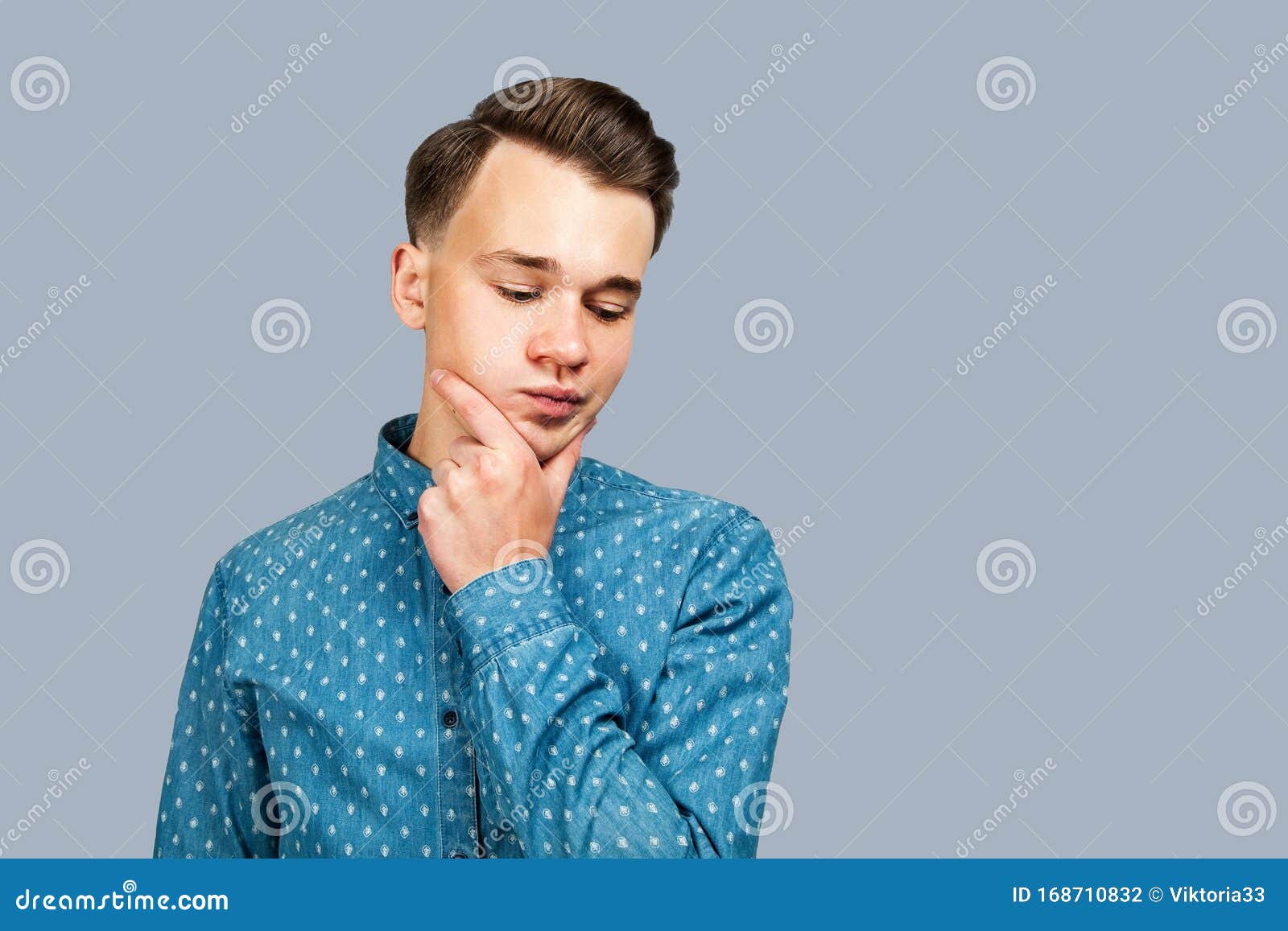 A Young Man Thinks on an Isolated Background in the Studio Stock Photo ...