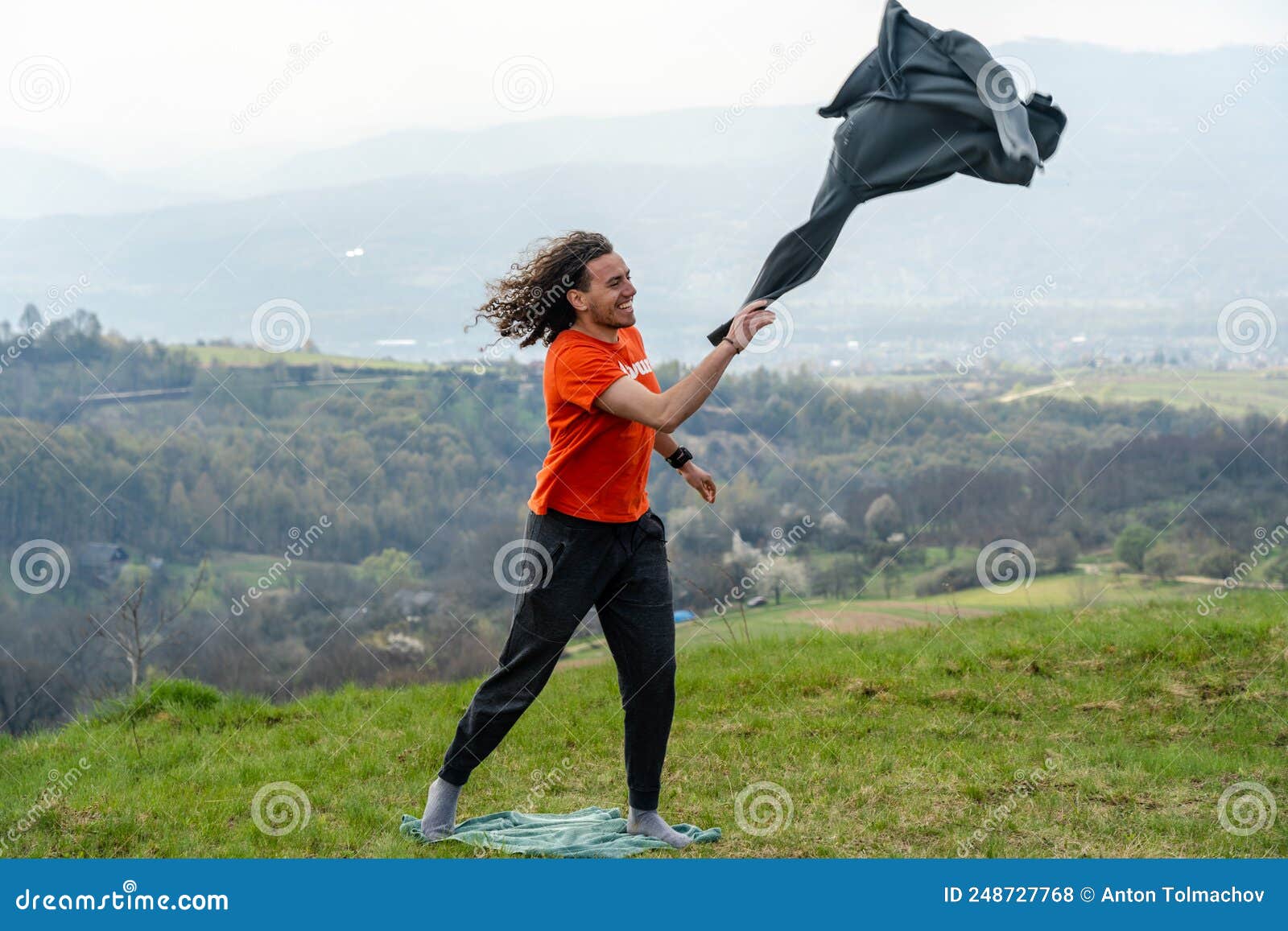 Young Man Throwing a Jacket in the Air on Mountain Stock Photo - Image ...
