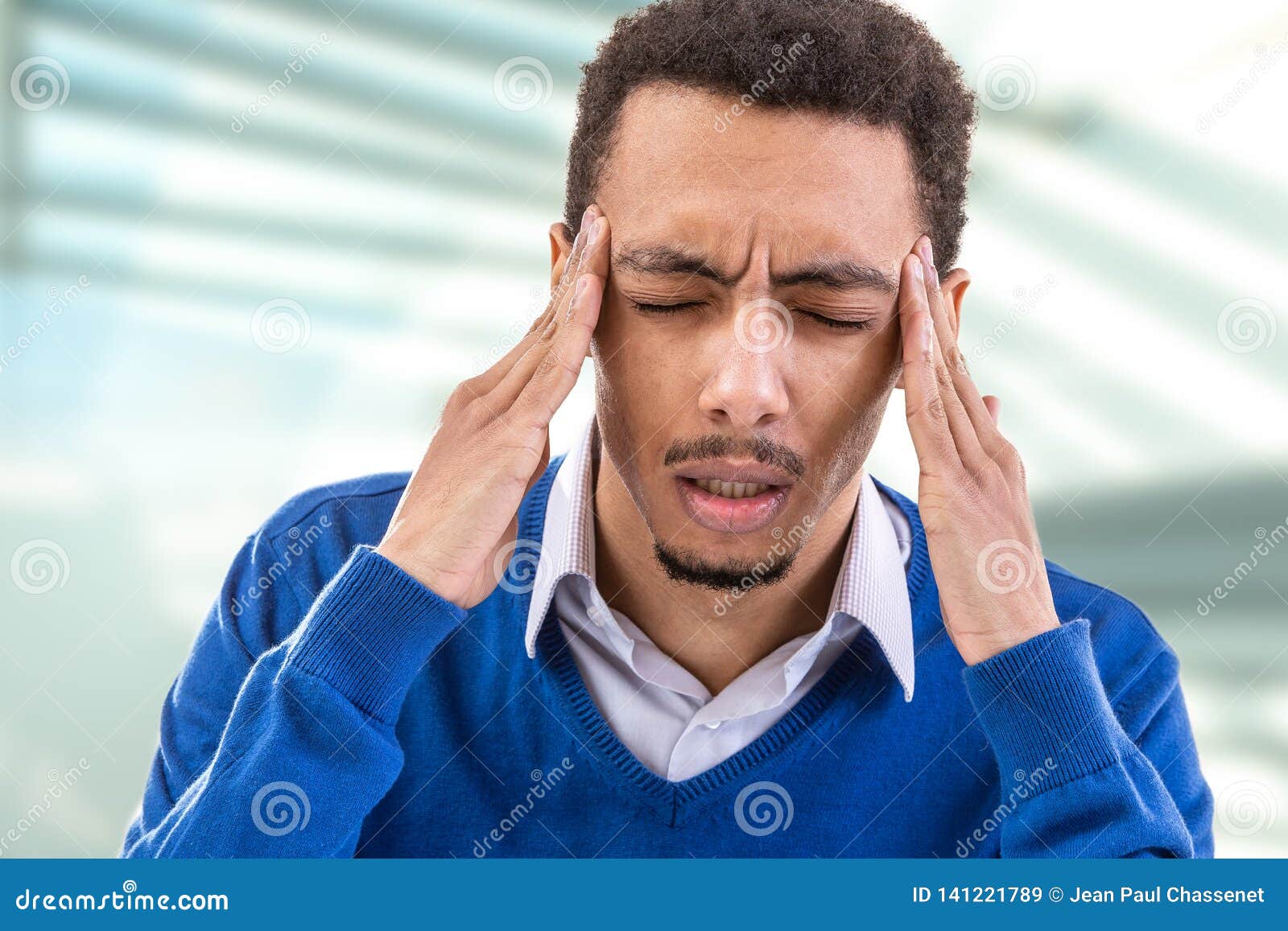 Young Man Touching Temples Trying To Focus or Feeling Headache. Stock ...