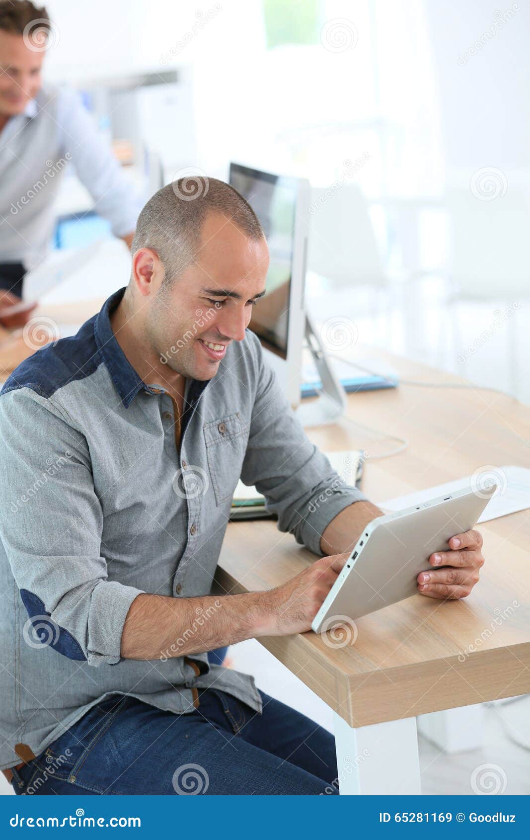 Young Man in Training Class Using Tablet Stock Image - Image of ...