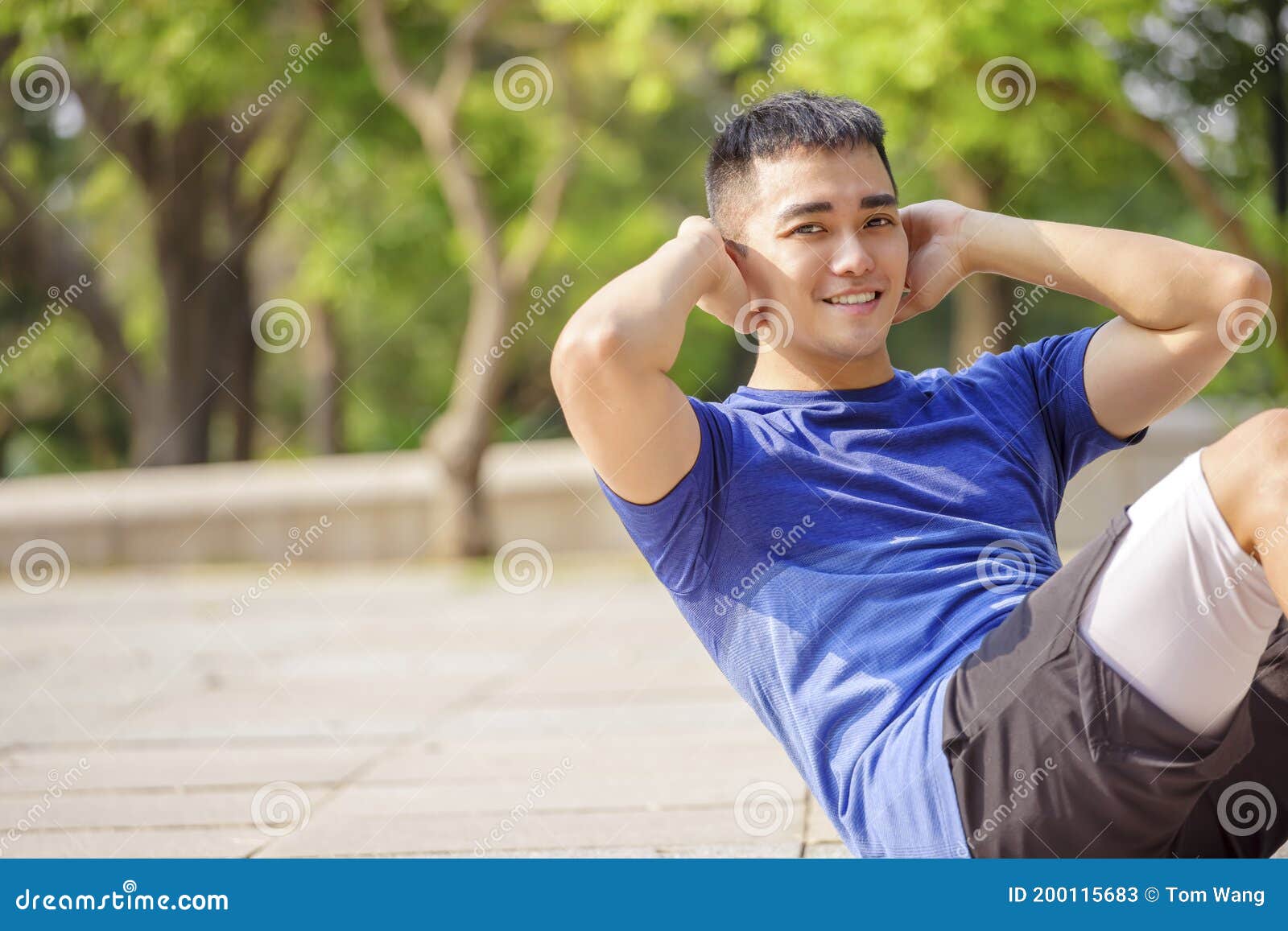 Young Man Training and Doing Sit Ups in Park Stock Image - Image of ...