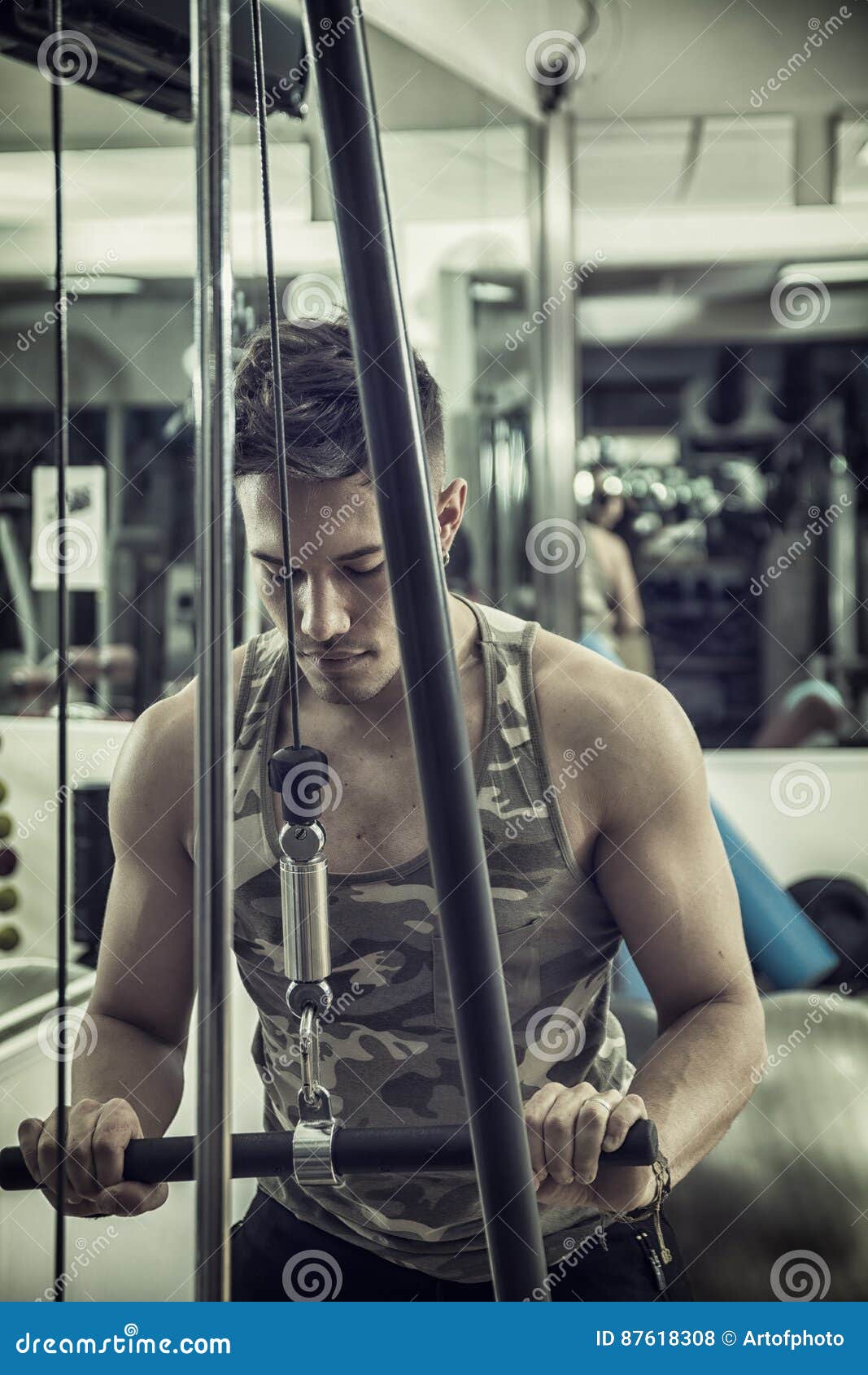 Young Man Training on Gym Equipment Stock Photo - Image of cable, pull ...