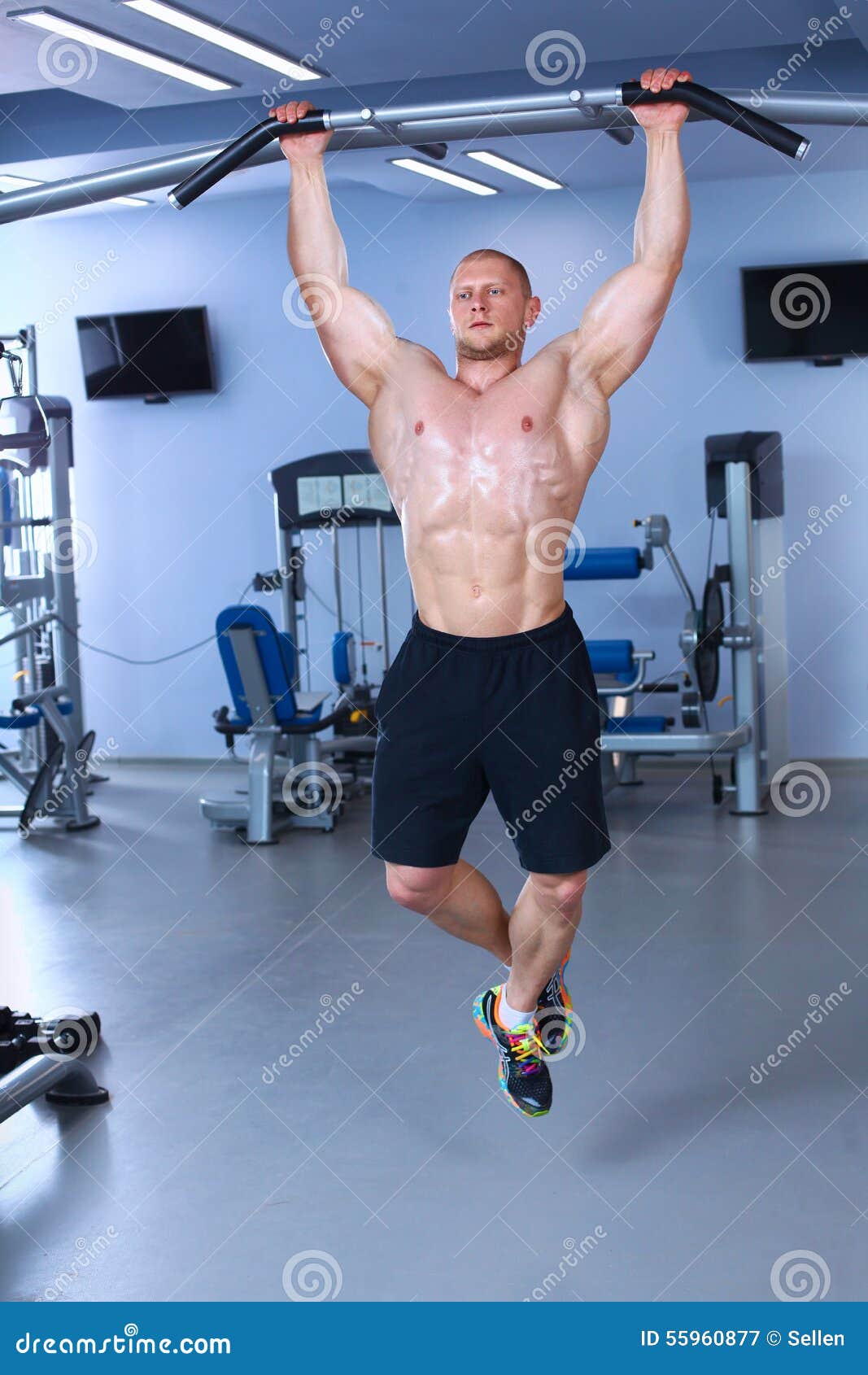 Young Man Training at Gym with Exercises Stock Image - Image of grey ...