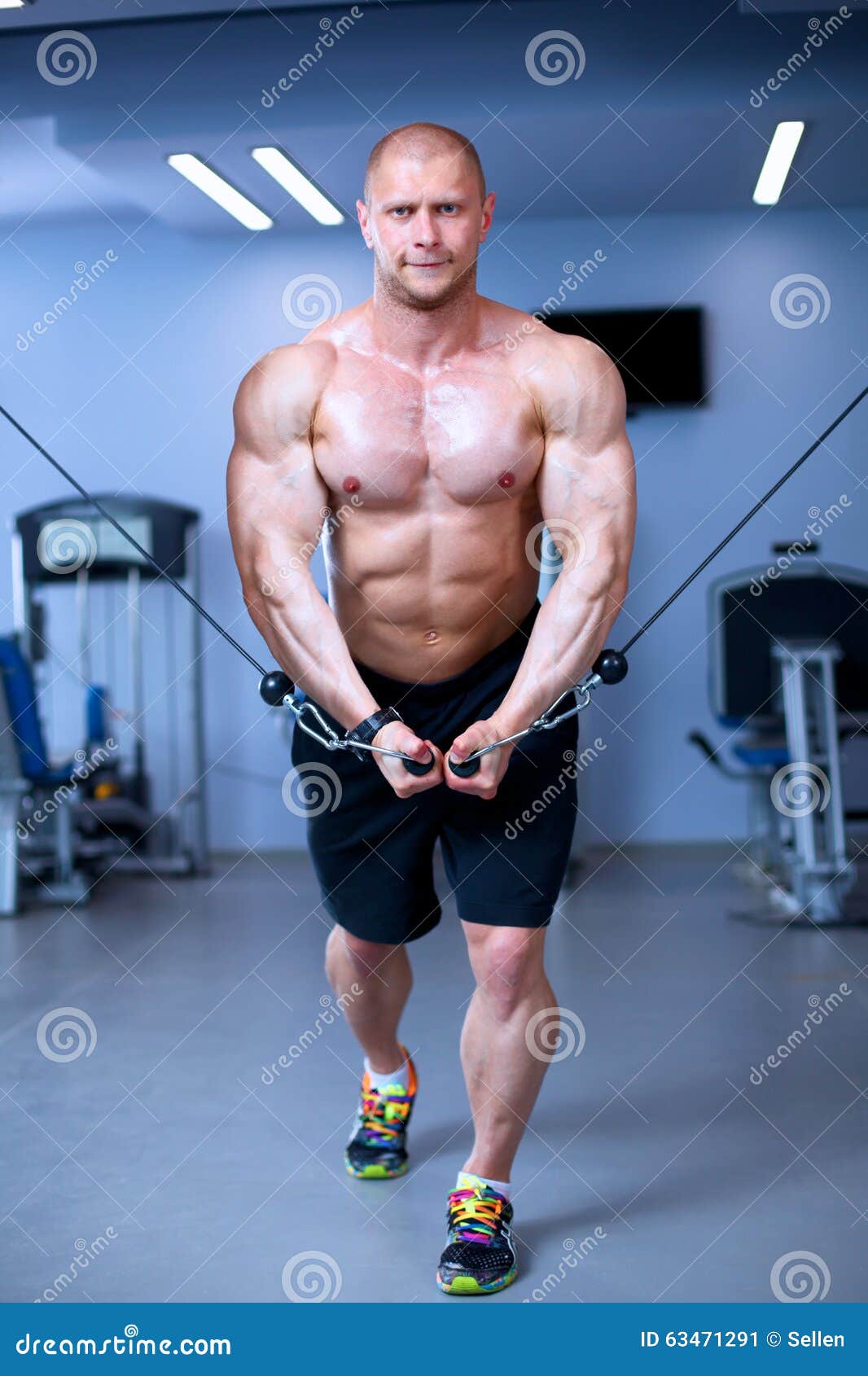 Young Man Training At Gym With Exercises Stock Photo - Image: 63471291