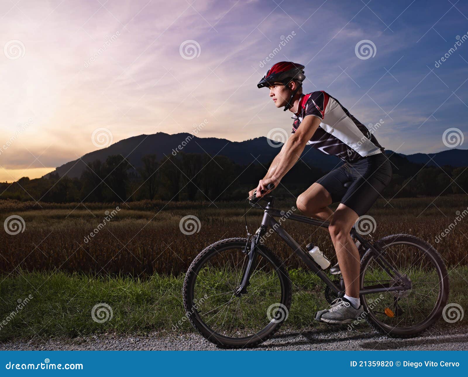 Young Man Training on Mountain Bike at Sunset Stock Photo - Image of ...