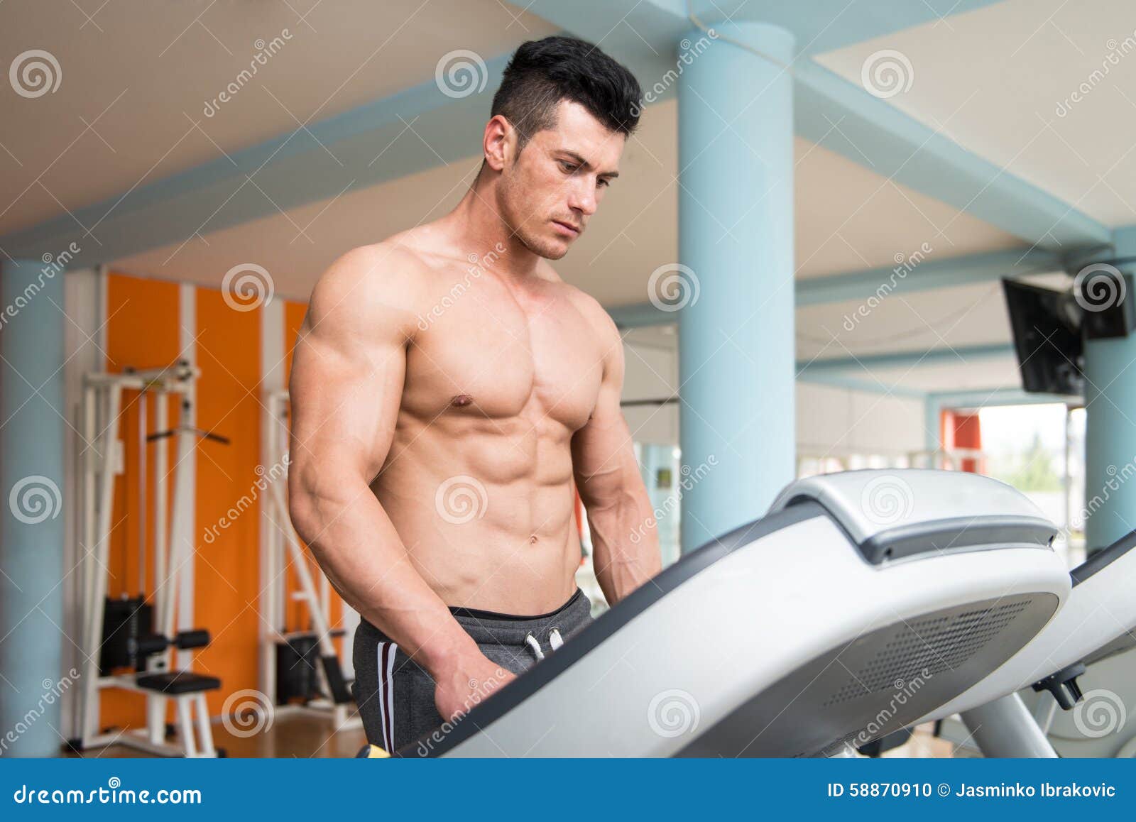 Young Man on Treadmill stock photo. Image of body, calves - 58870910